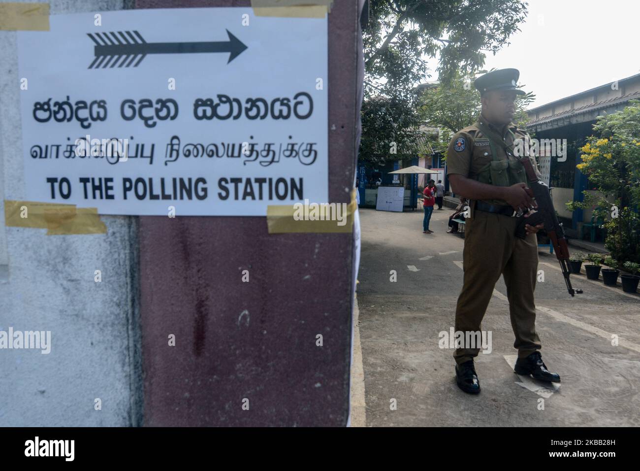 Sri Lankan polices officer stand guards next to the polling station ...