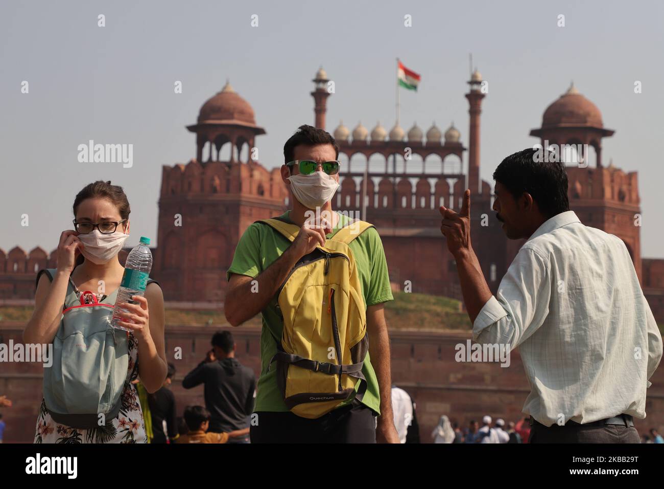 Foreign tourists wearing masks walks in the premises of the Red fort on ...