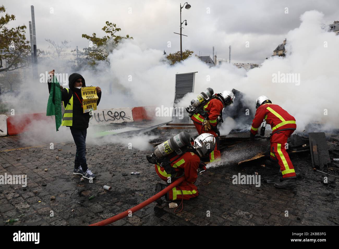 French firemen extinguishe a burning barricade as protests to mark the ...