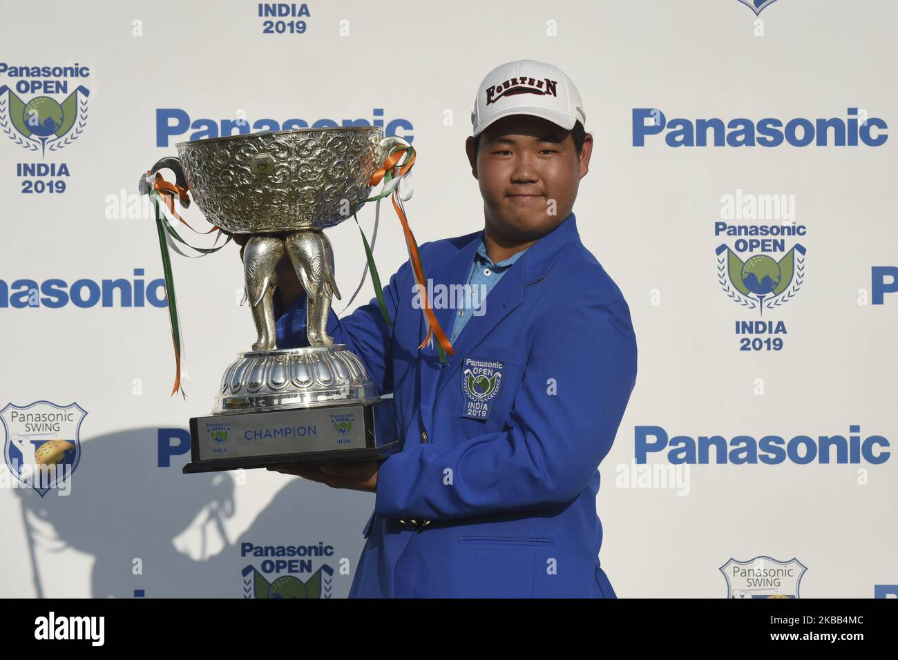 South Korea's Joohyung Kim holds the trophy as he poses for photographs ...