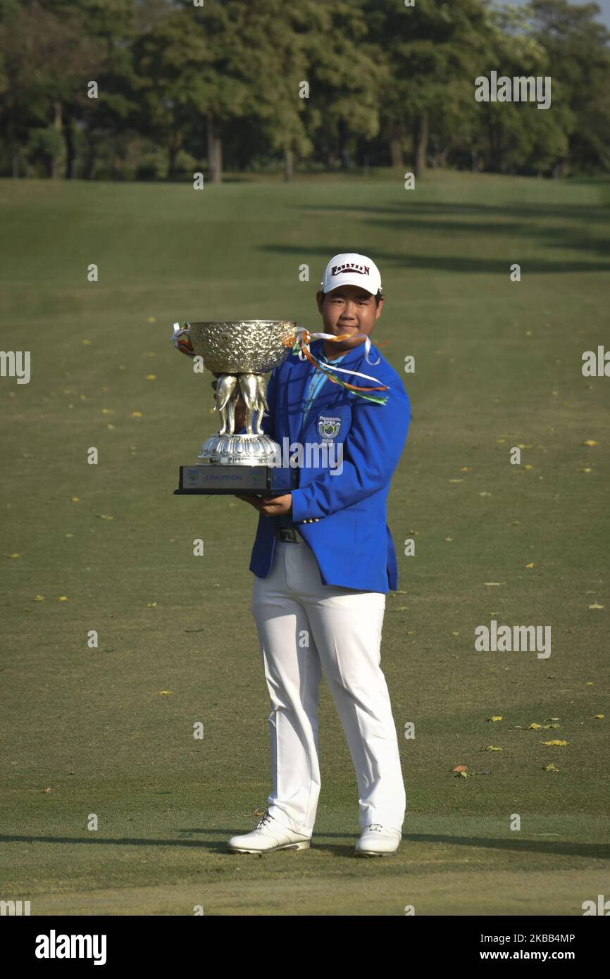 South Korea's Joohyung Kim holds the trophy as he poses for photographs ...