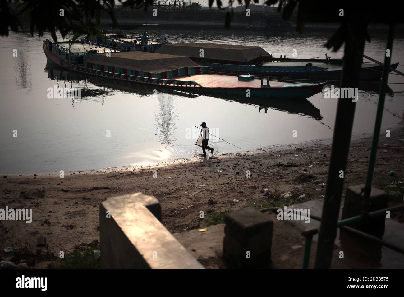 A boy seen fishing in The Turag river in Dhaka , Bangladesh on 17 ...