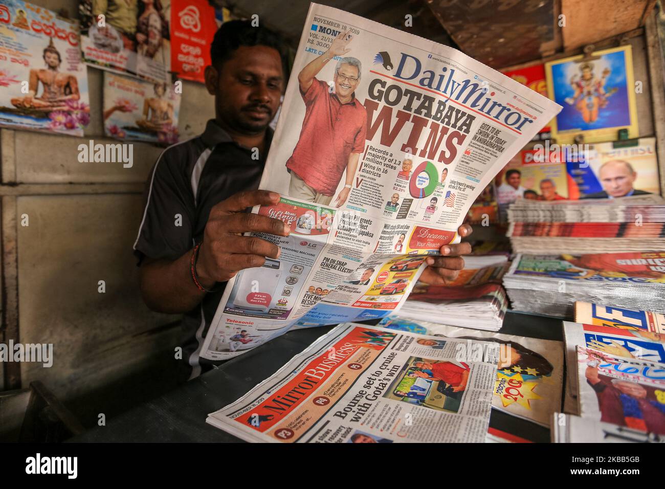 A Sri Lankan man reads a Sri Lankan newspaper front pages headlining ...