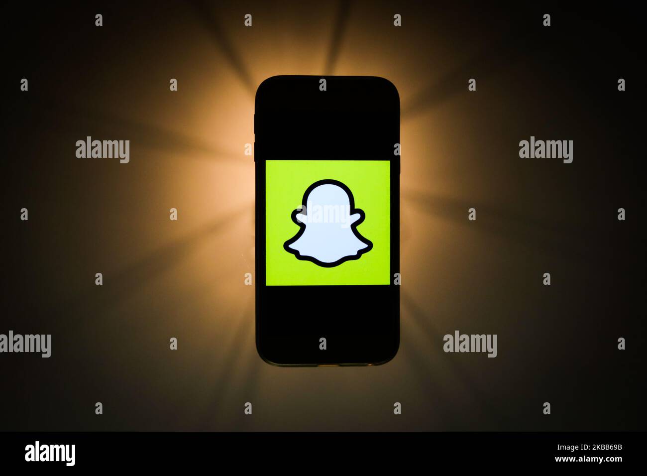 Snapchat logo is seen displayed on a phone screen in this illustration ...