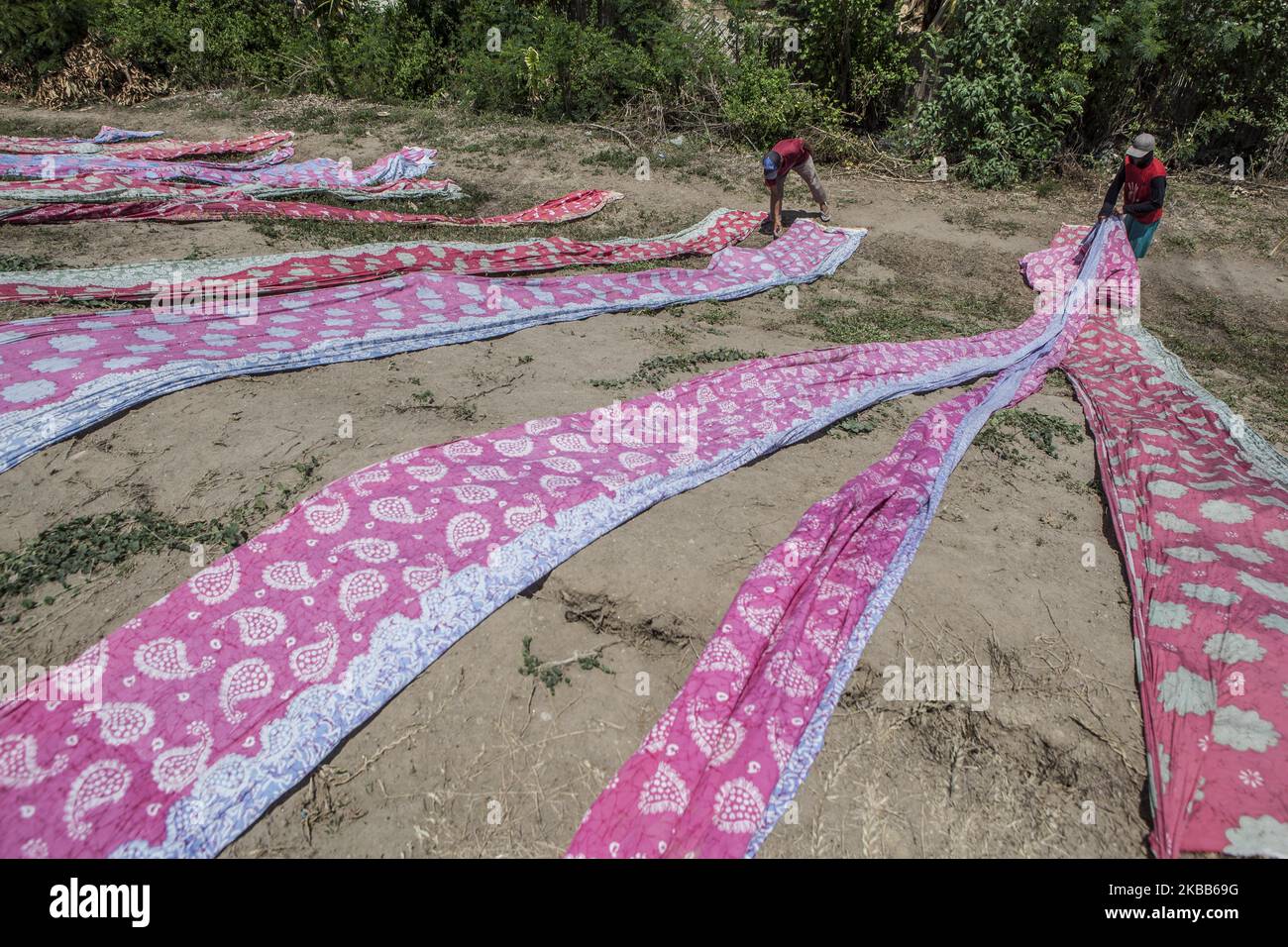 A workers drying cloth which is the raw material for making clothes in ...