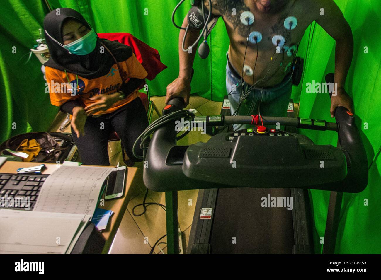 A man undergoing an Exercise Stress Test walking and running on a ...