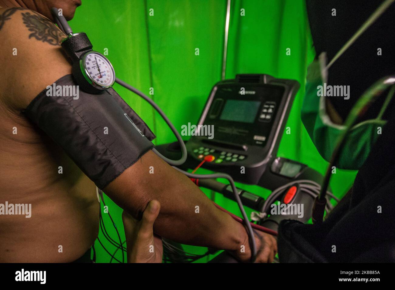 A man undergoing an Exercise Stress Test walking and running on a ...