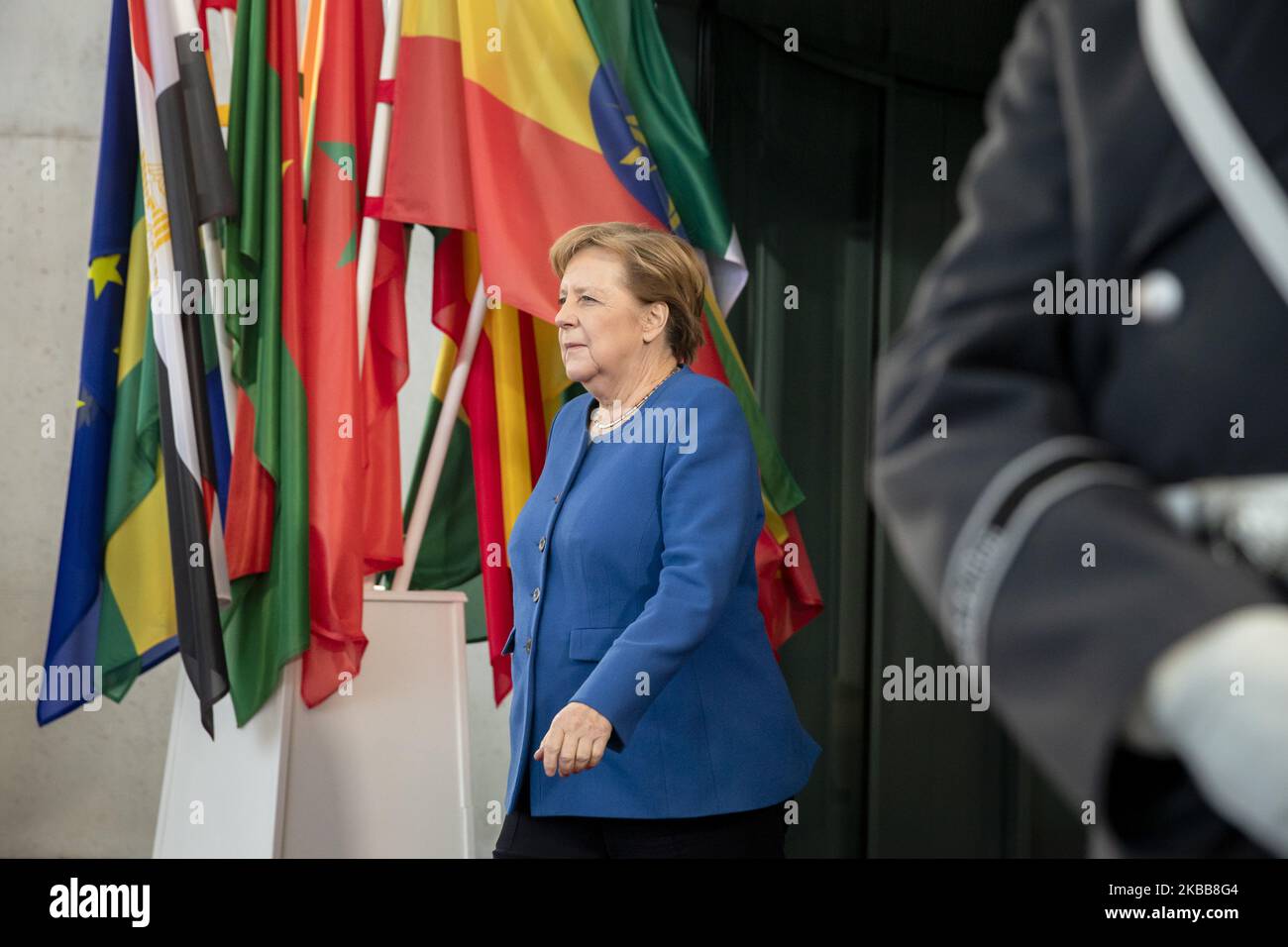 German Chancellor Angela Merkel waits for dignitaries to arrive at the ...