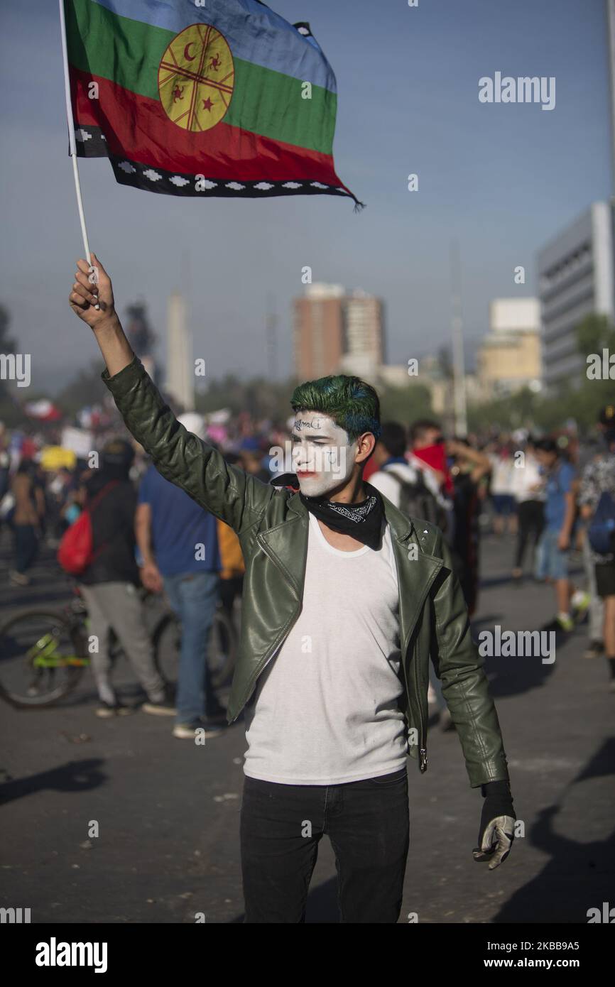 A demonstrator holds a Mapuche flag during a protest against Chile's ...