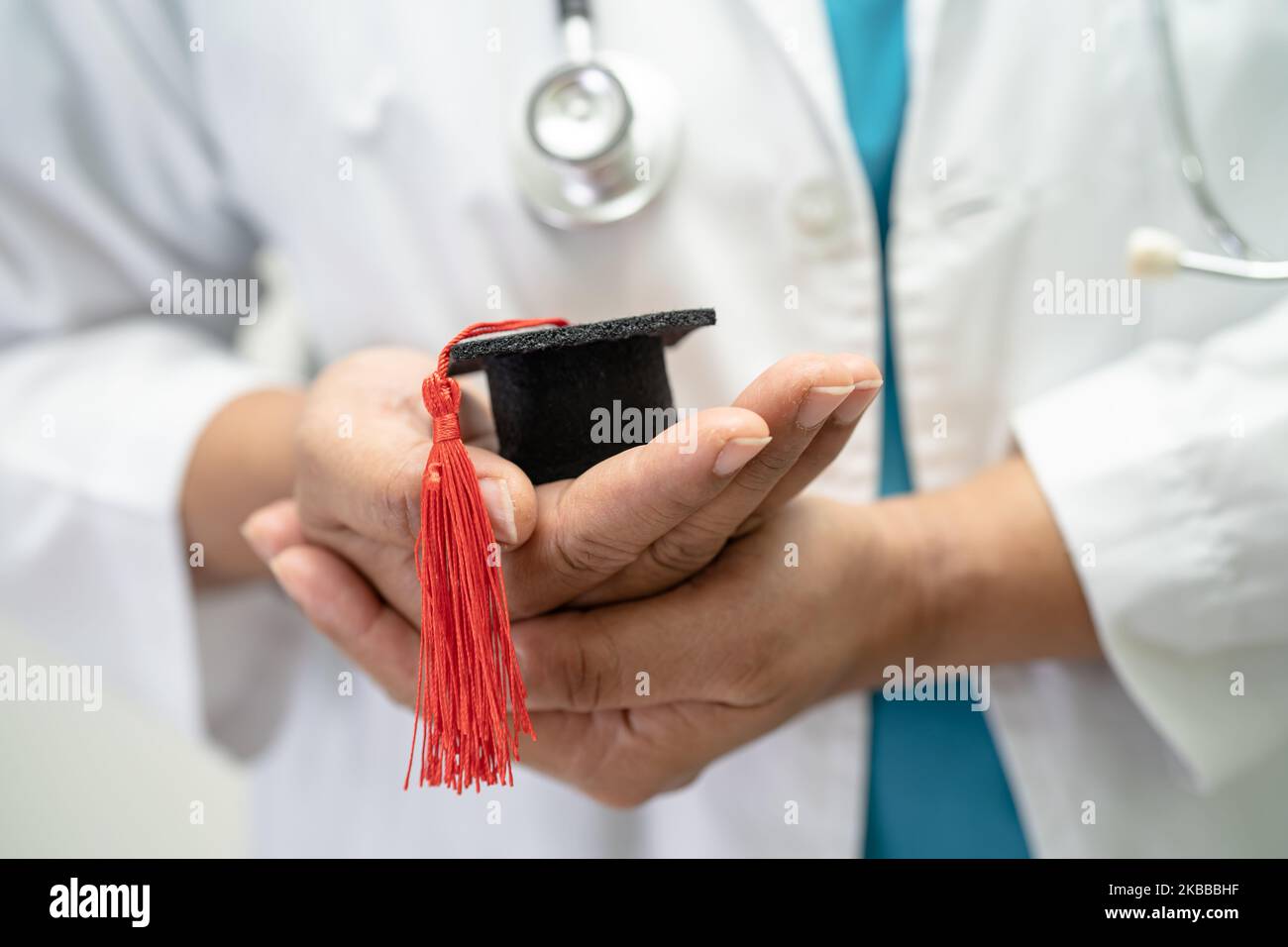 Asian doctor study learn with graduation gap hat in hospital ward ...