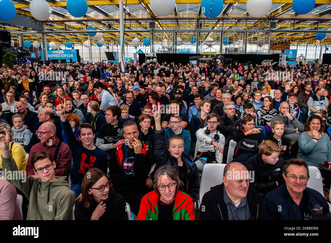 Young audience are raising their hands to be chosen by James Hobson ...