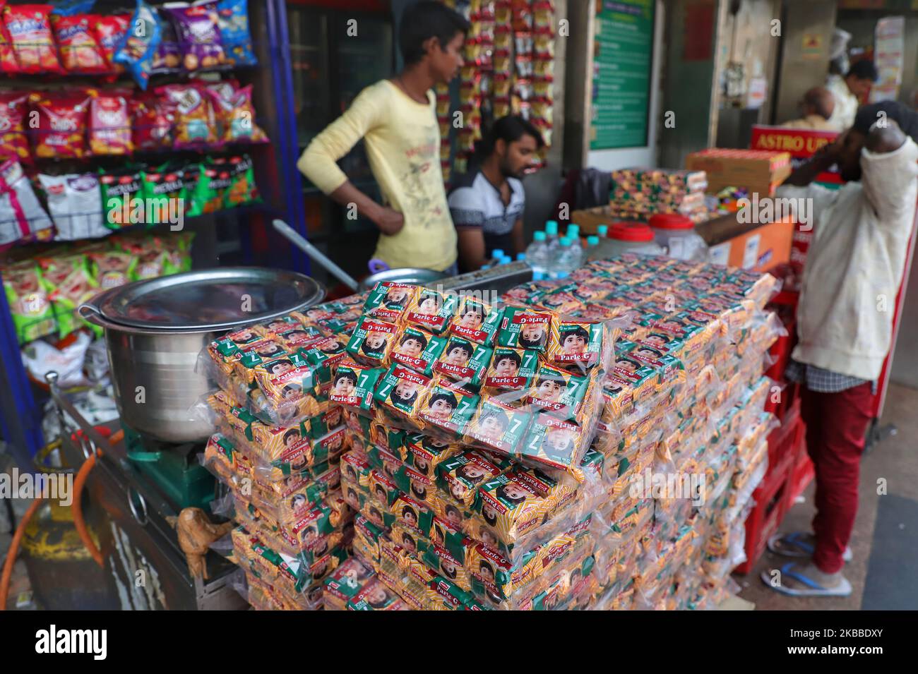A shopkeeper selling Parle-G biscuits and other products near a Metro ...