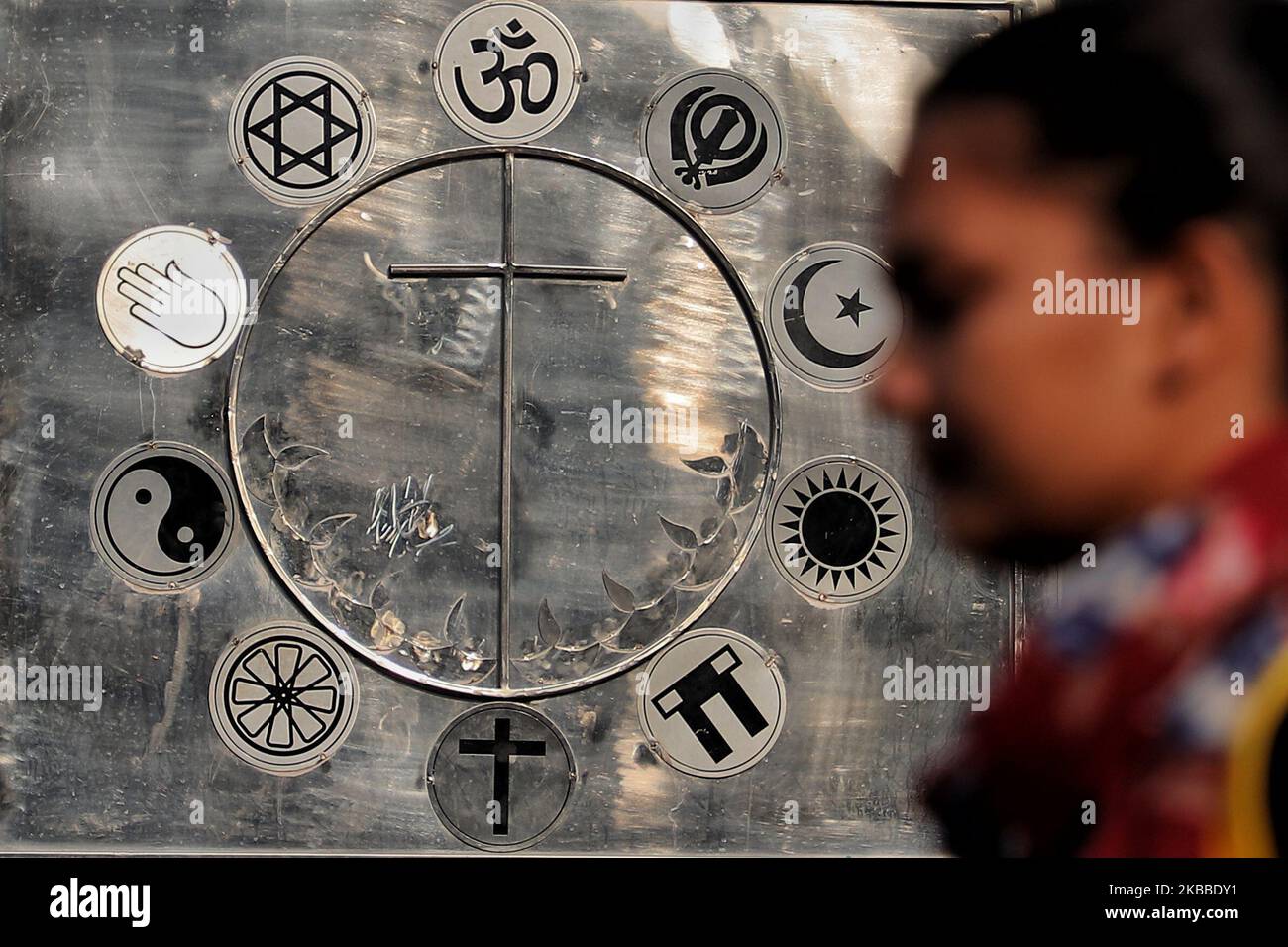 A women walking past a steel board in New Delhi India with signs of ...
