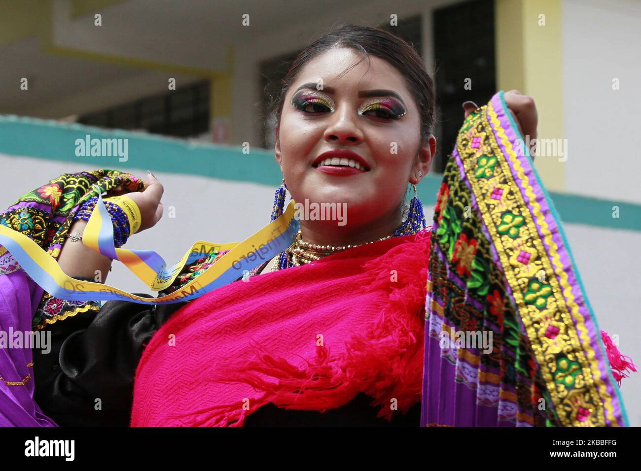 A performer dressed as the Chola walks the streets during the Mama ...
