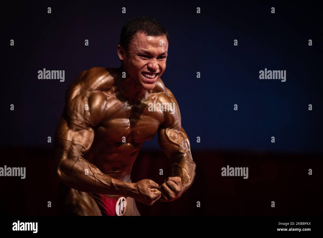 Male bodybuilding athlete poses on stage during the 46th State and ...