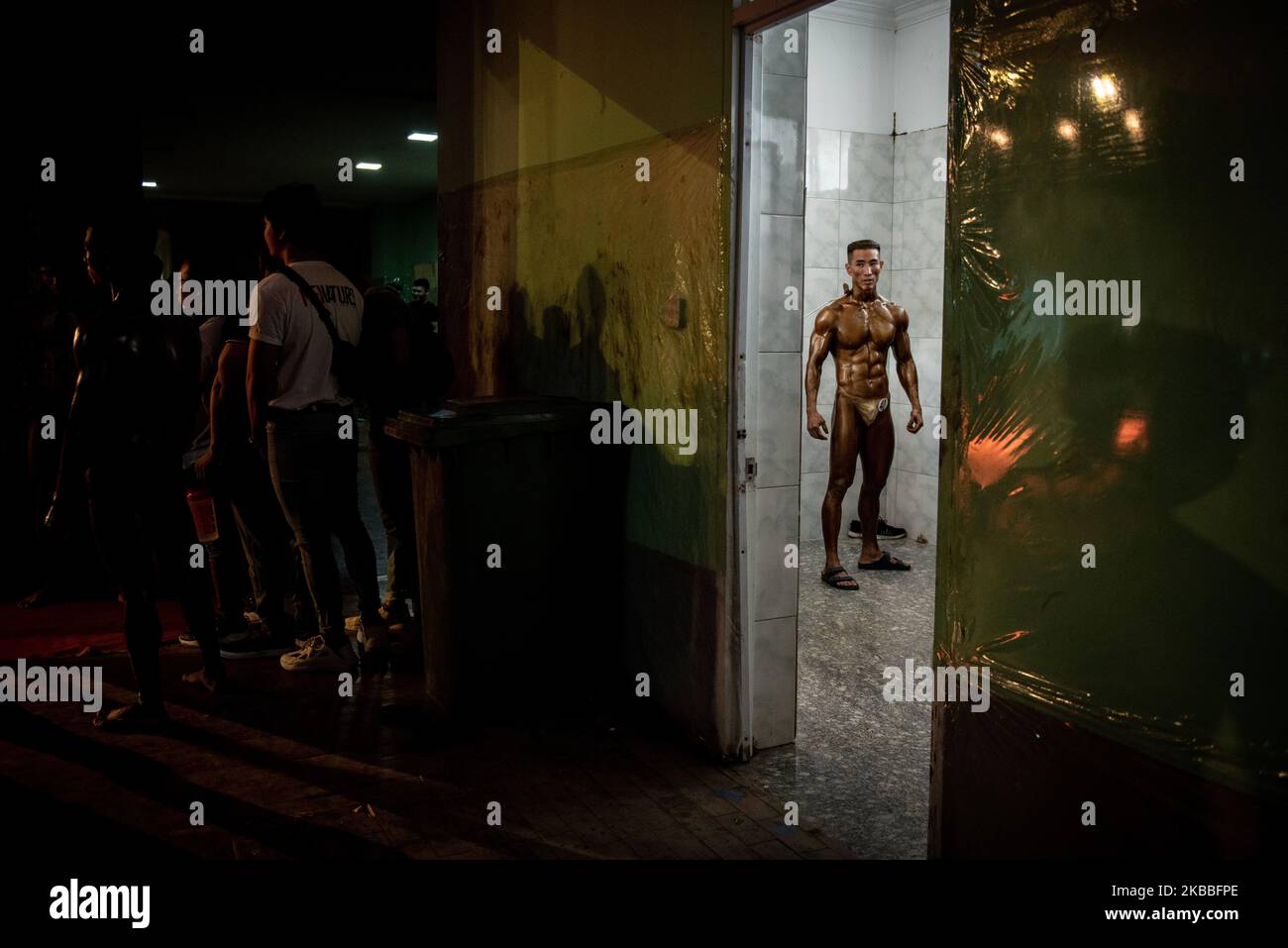 Male bodybuilding athlete prepares backstage during the 46th State and ...