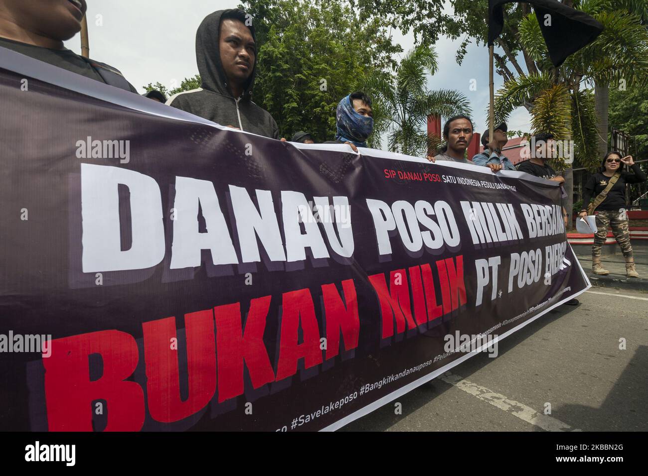 Students carry banners while holding a demonstration to save Lake Poso ...