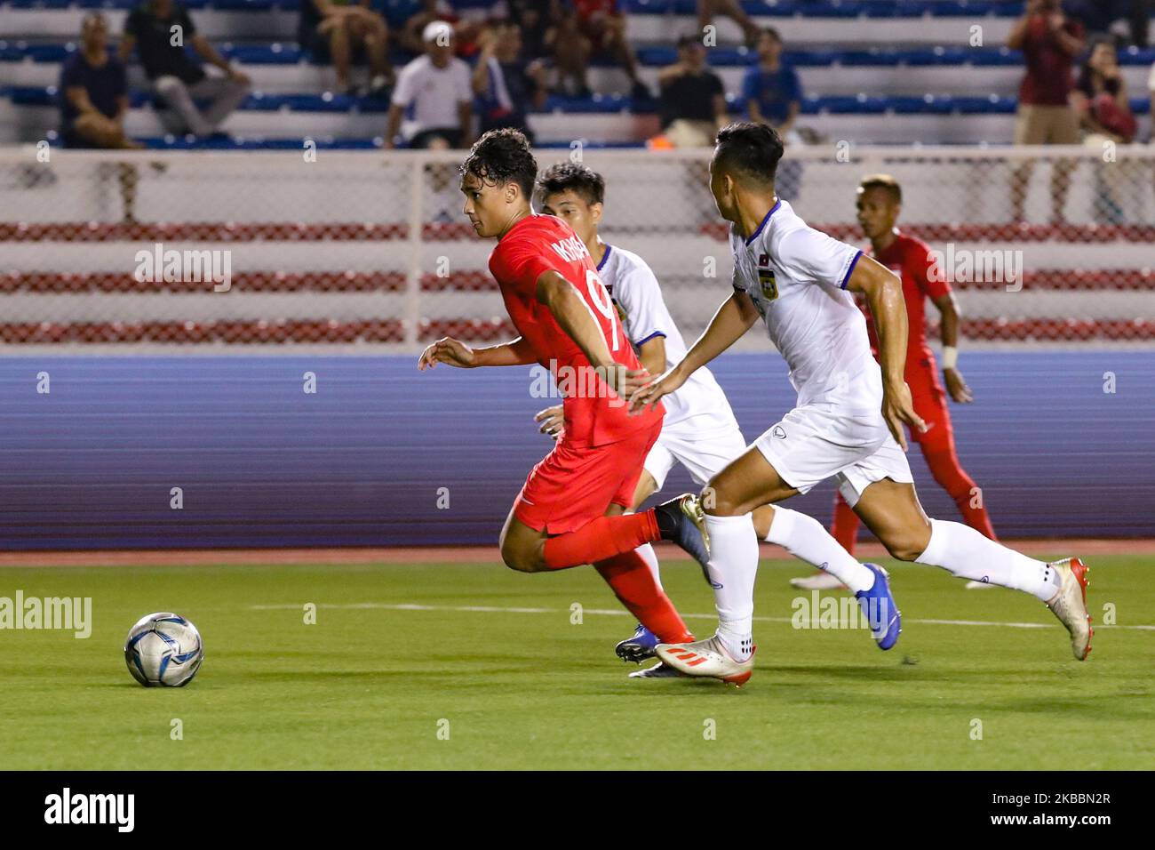 Ikhsan Fandi Ahmad (in red) of Singapore controls the ball during their ...