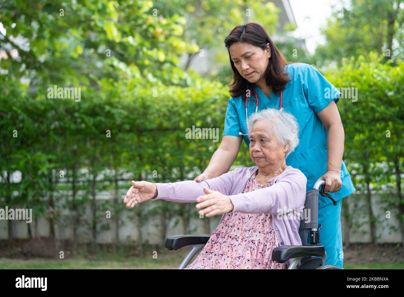 Doctor help Asian senior or elderly old lady woman patient exercise on ...