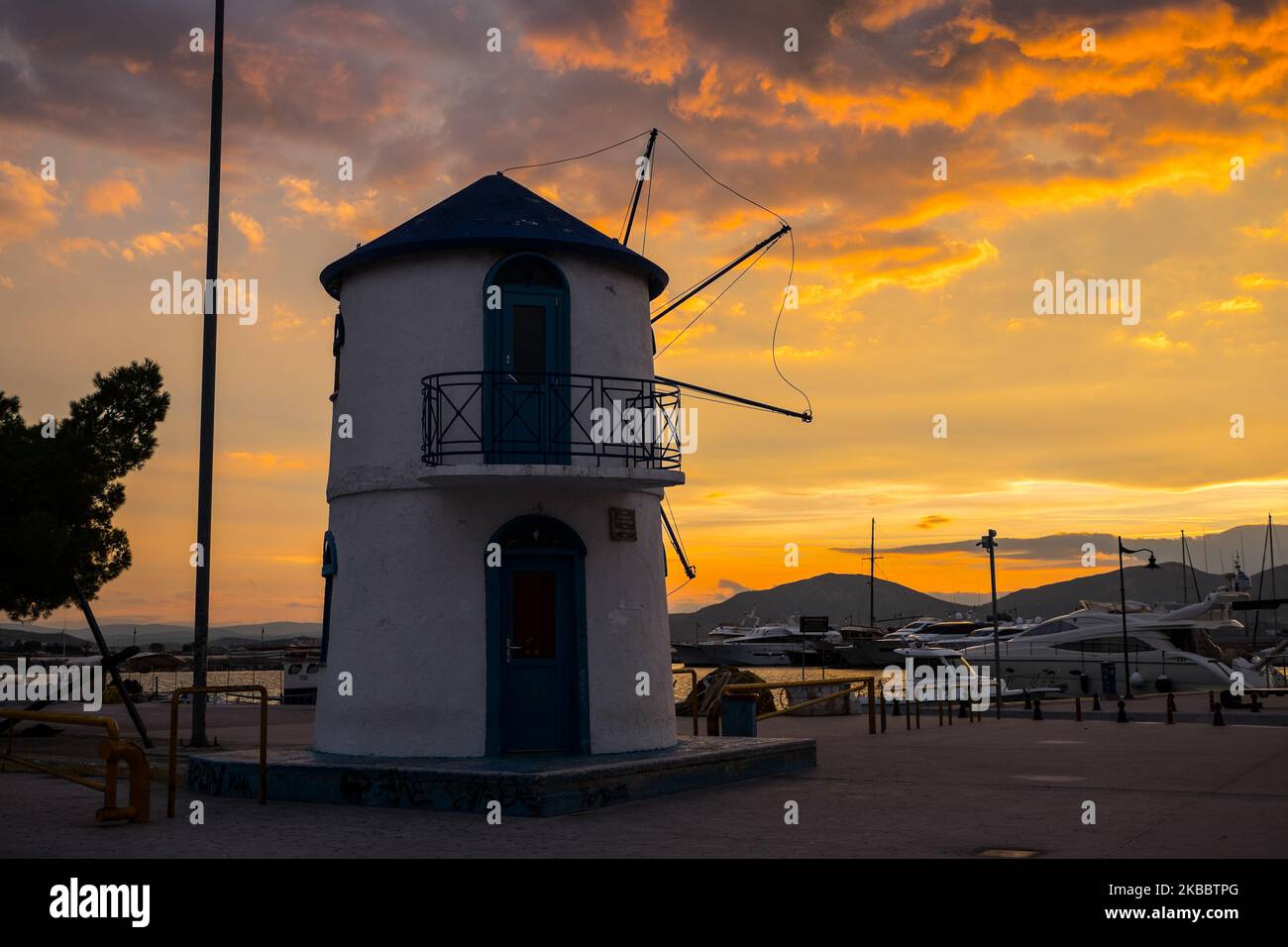Sunset with clouds in the sky at the harbor of Nea Artaki on the island ...