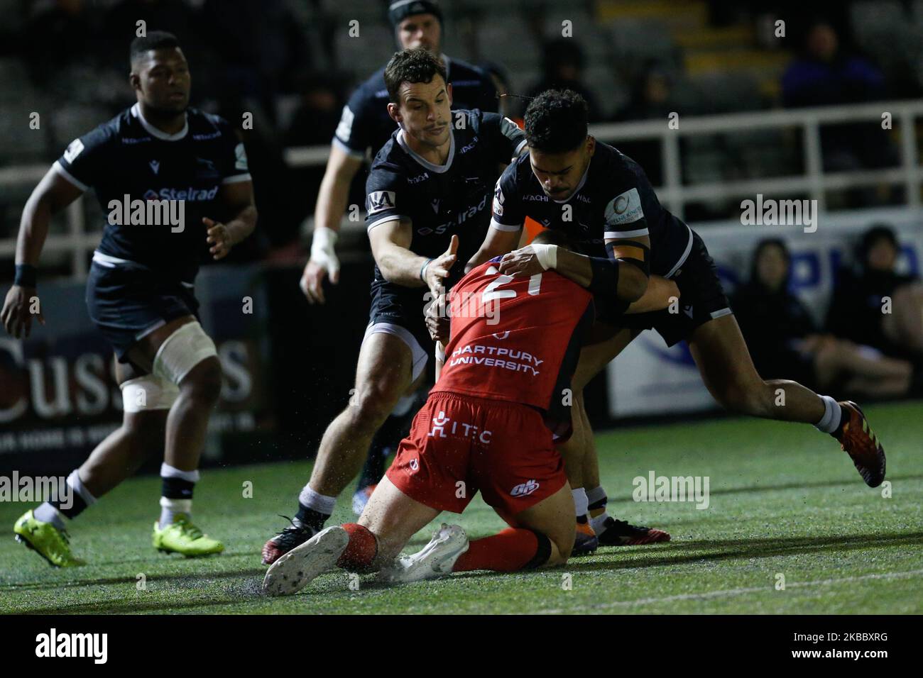Newcastle falcons tackles luke carter of hartpury university rfc hi-res ...