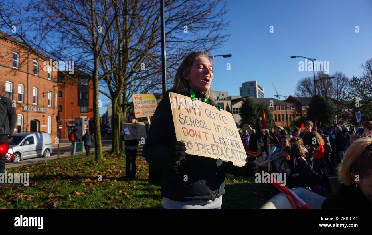 A students holds a sign while shouts slogans during the climate protest ...