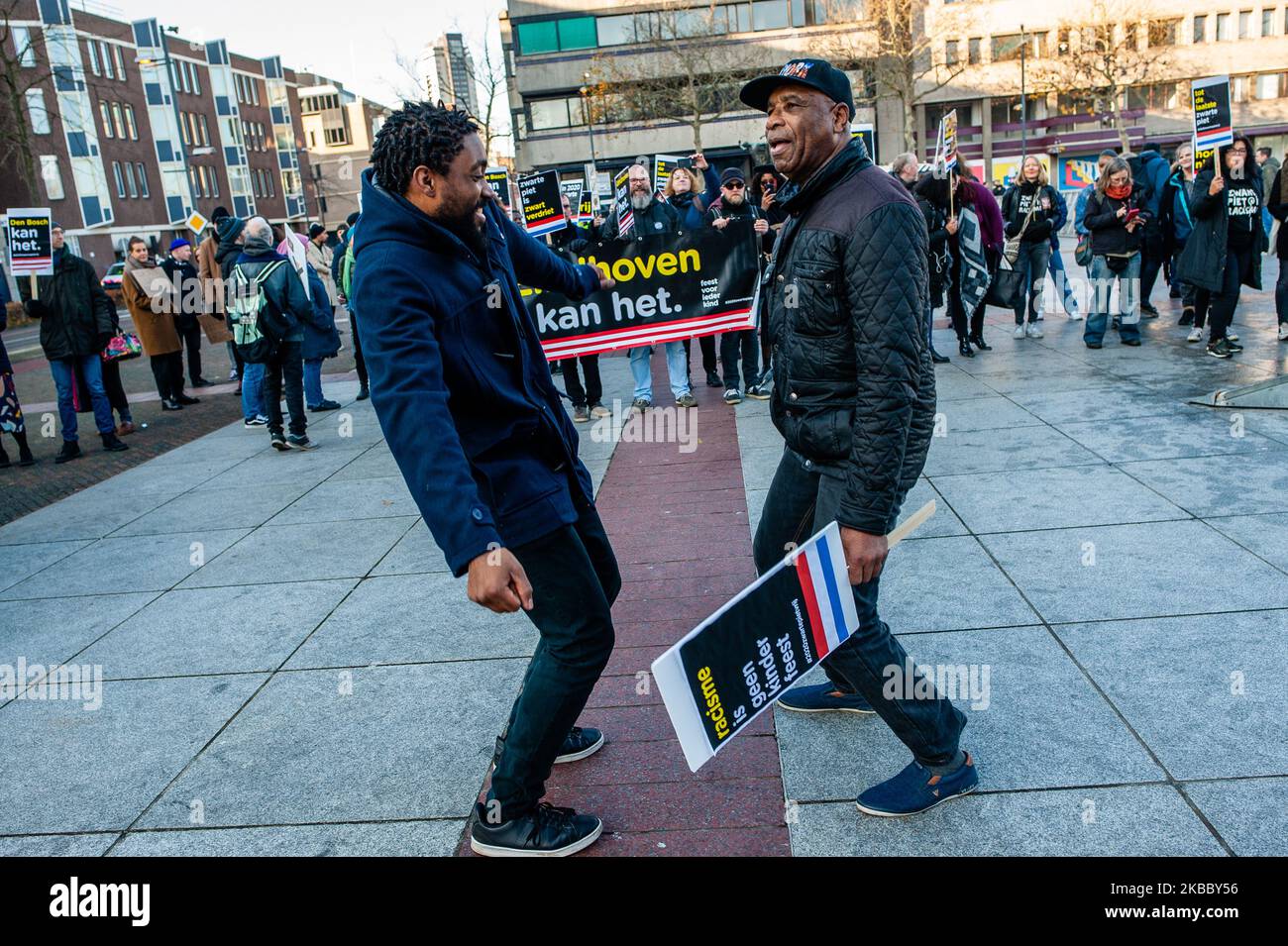 Two black men are dancing in front of the banners, during the Anti ...