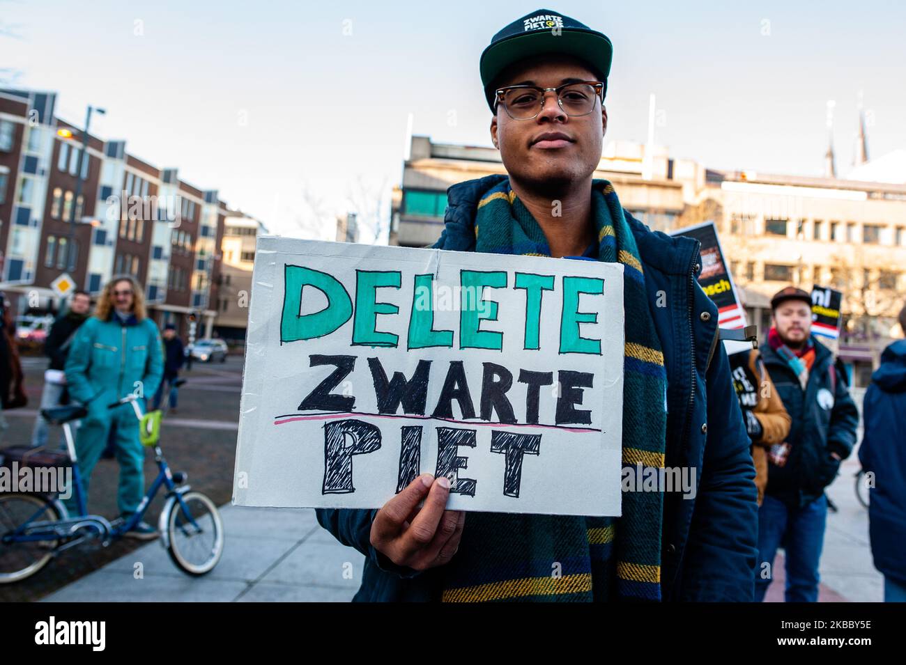 A Black man is holding a placard, during the Anti Black Piet rally in ...