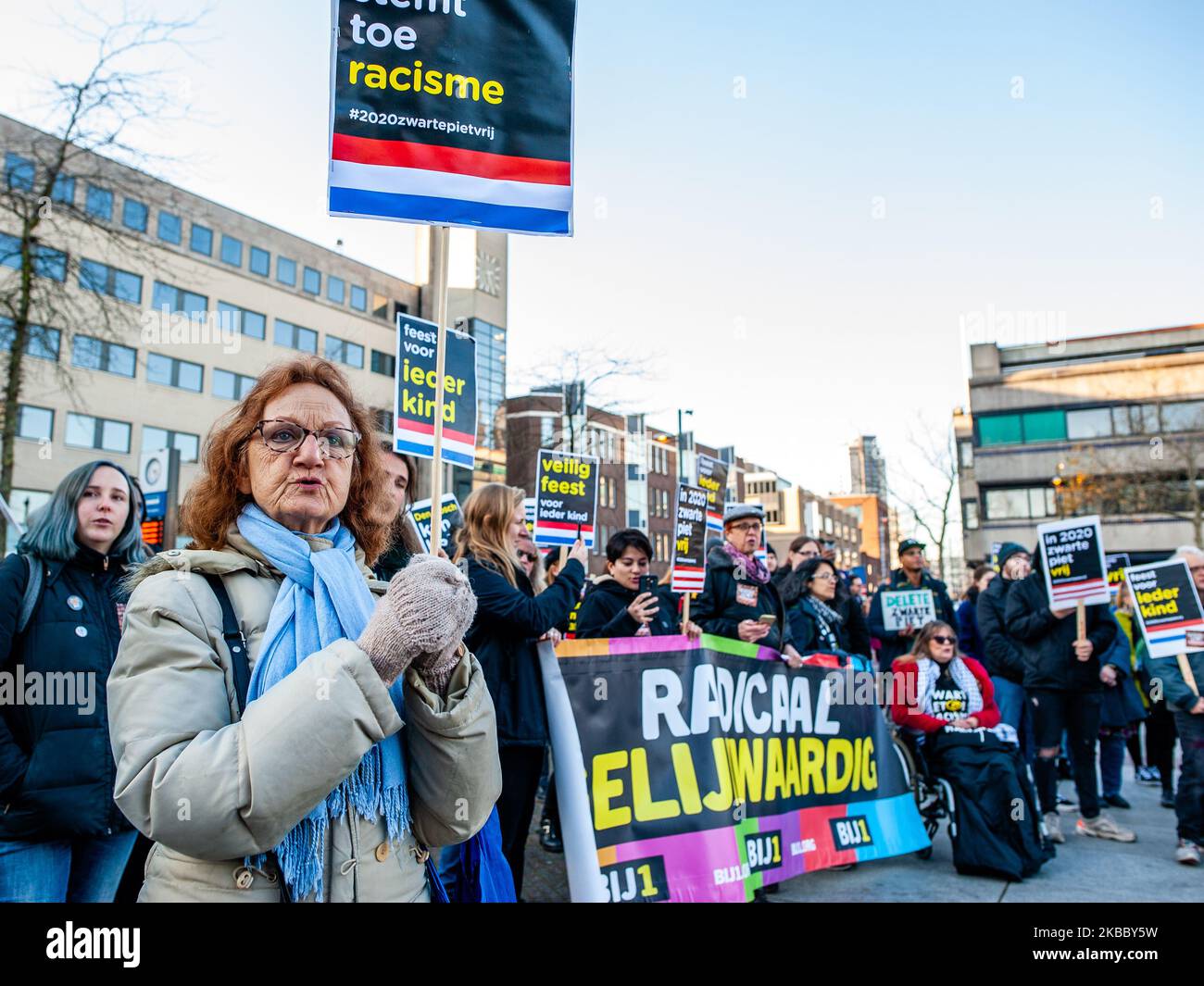 A group of people are holding placards and shouting slogans, during the ...