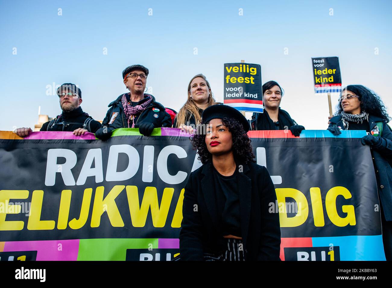 A Black woman is posing in front of the principal banner during the ...