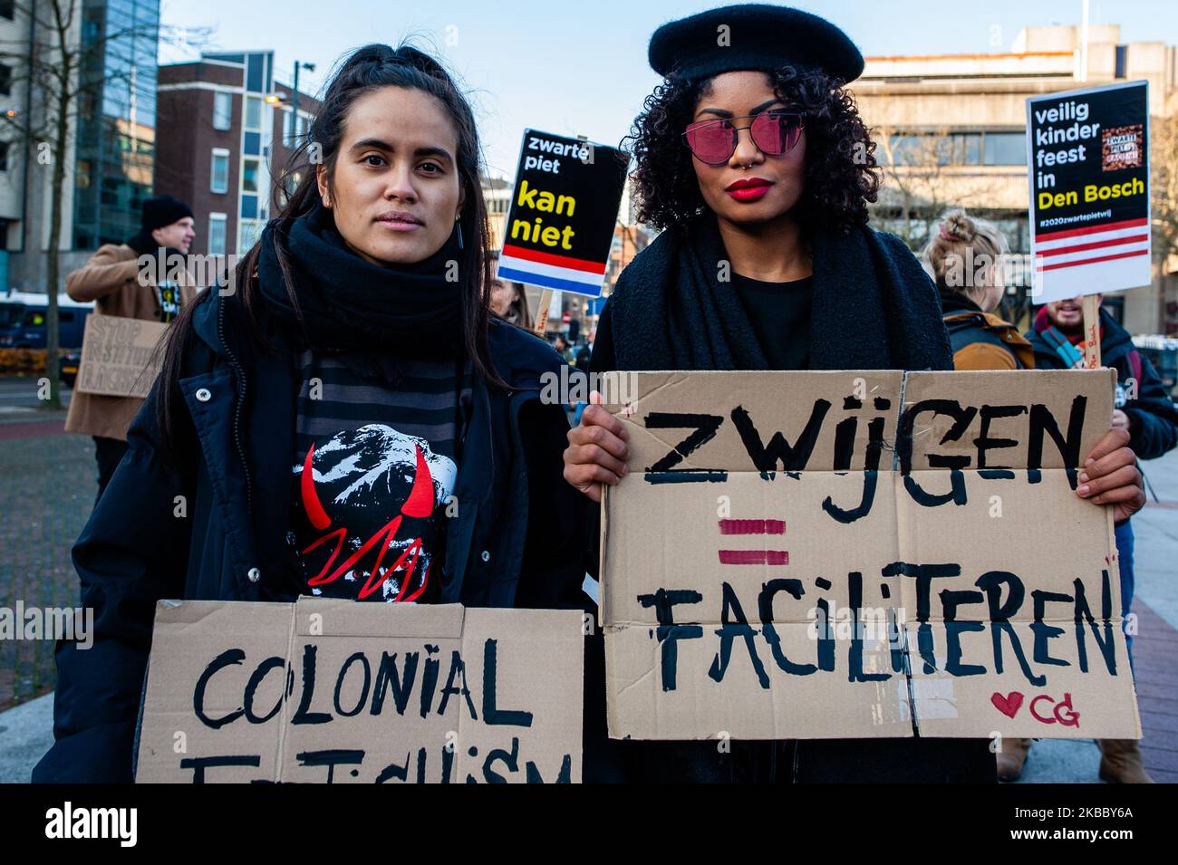 Two women are holding anti Black Piet placards during the rally Anti ...