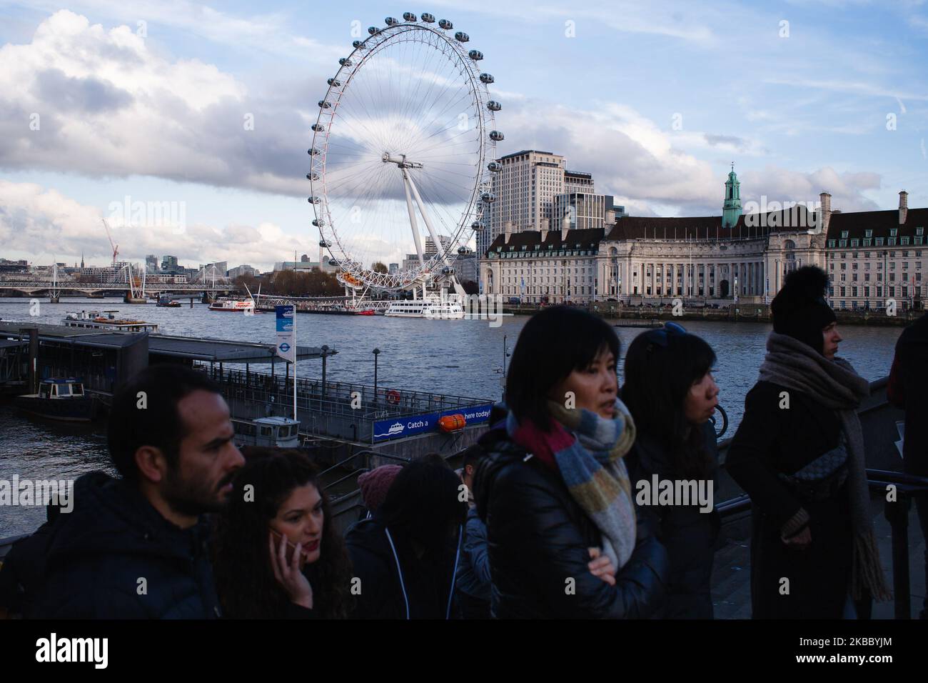 The London Eye ferris wheel, a major tourist attraction, stands beside ...