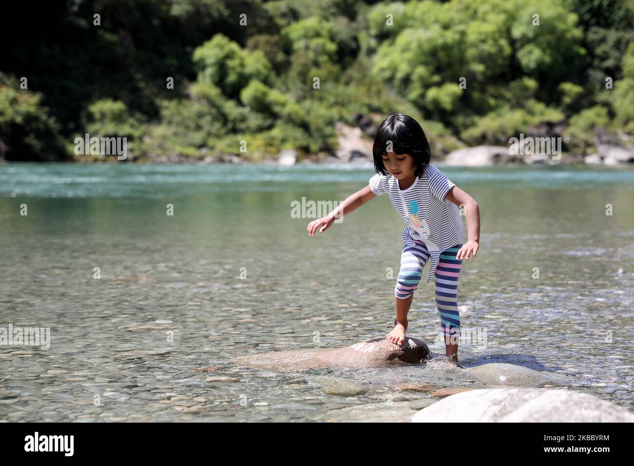 A little girl Minudi Menulya walks through the water at The Buller ...