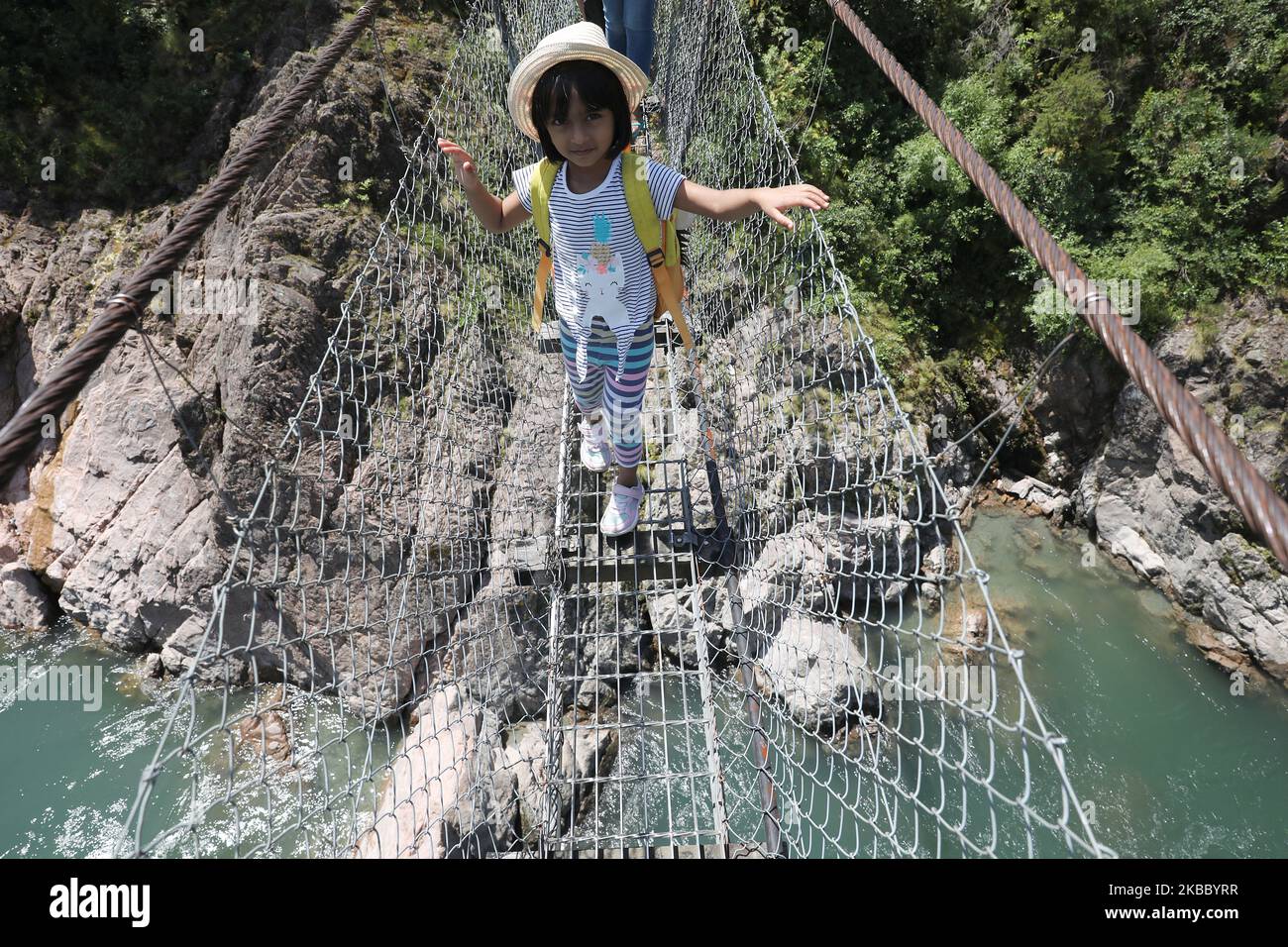 Little girl Minudi Menulya crossesÂ Buller Gorge Swingbridge, New ...
