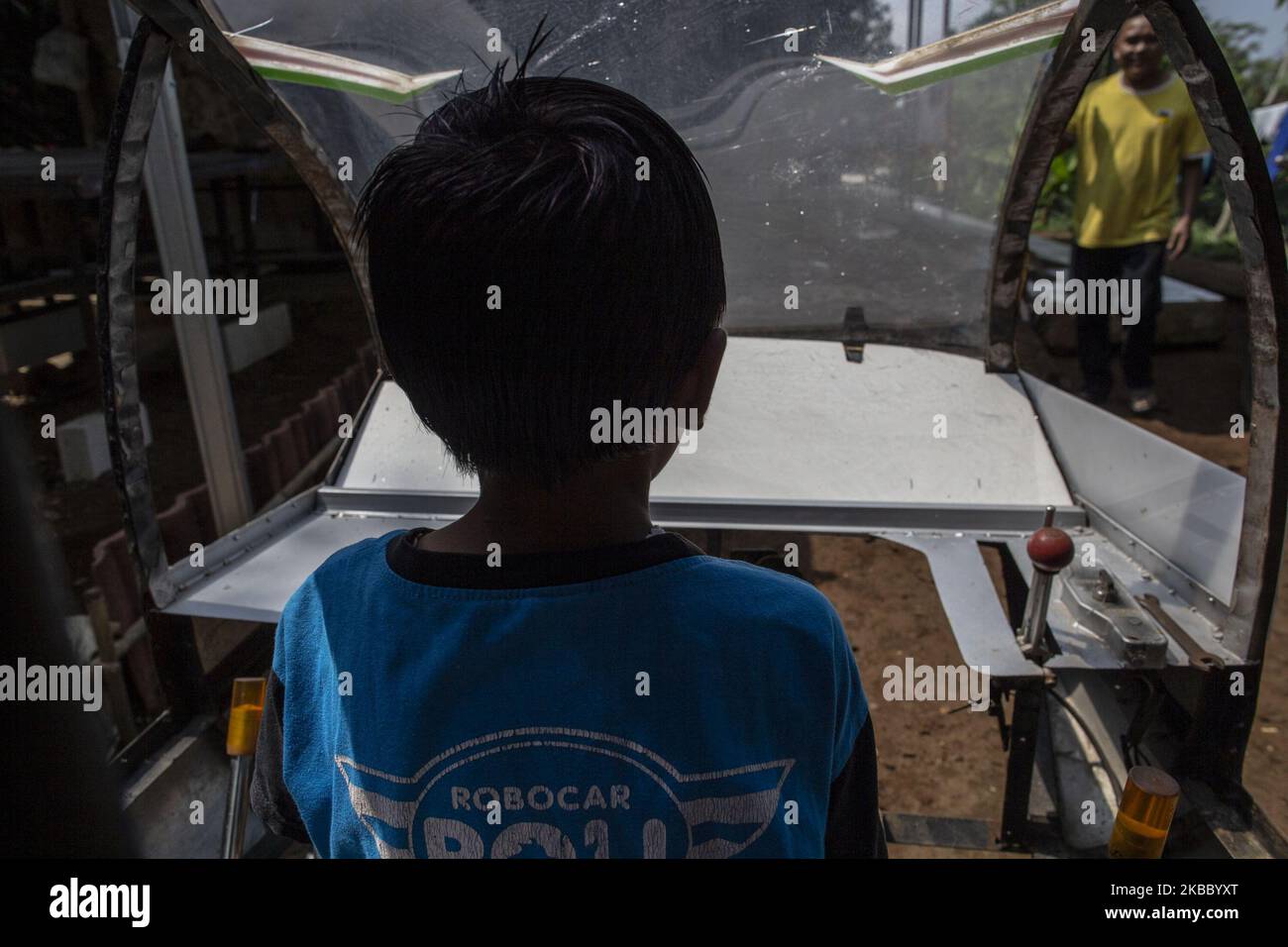 Jujun Junaedi, with his young son Dede Rafka assistant build a ...