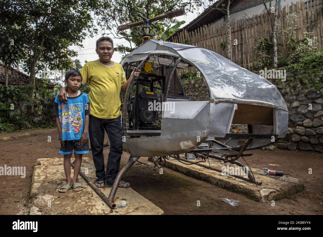 Jujun Junaedi, with his young son Dede Rafka assistant build a ...