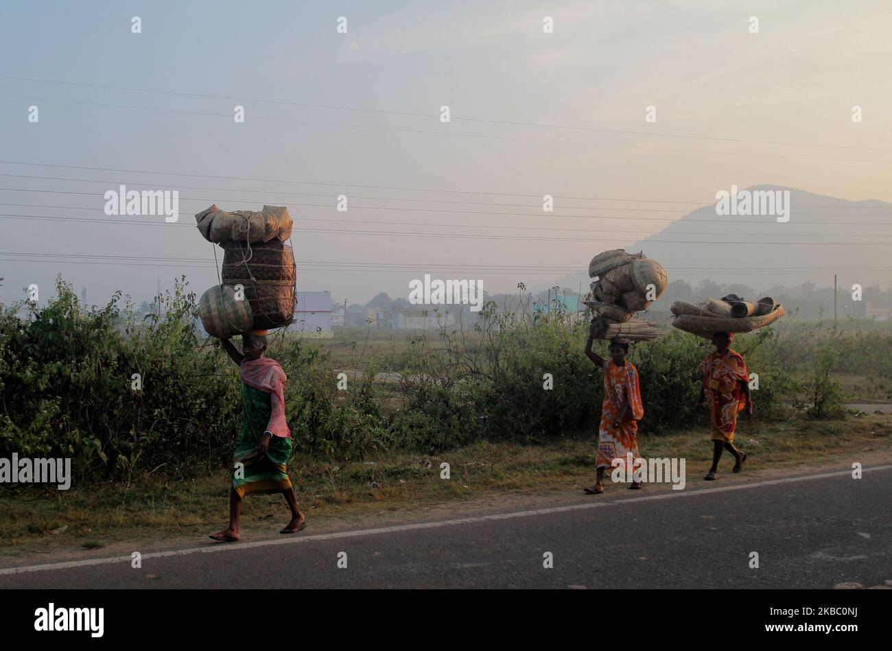 Villagers are seen inside the Balimela reservor as they moves out by ...