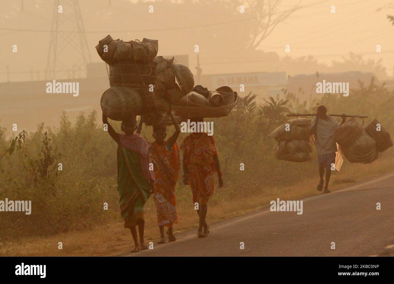 Villagers are seen inside the Balimela reservor as they moves out by ...