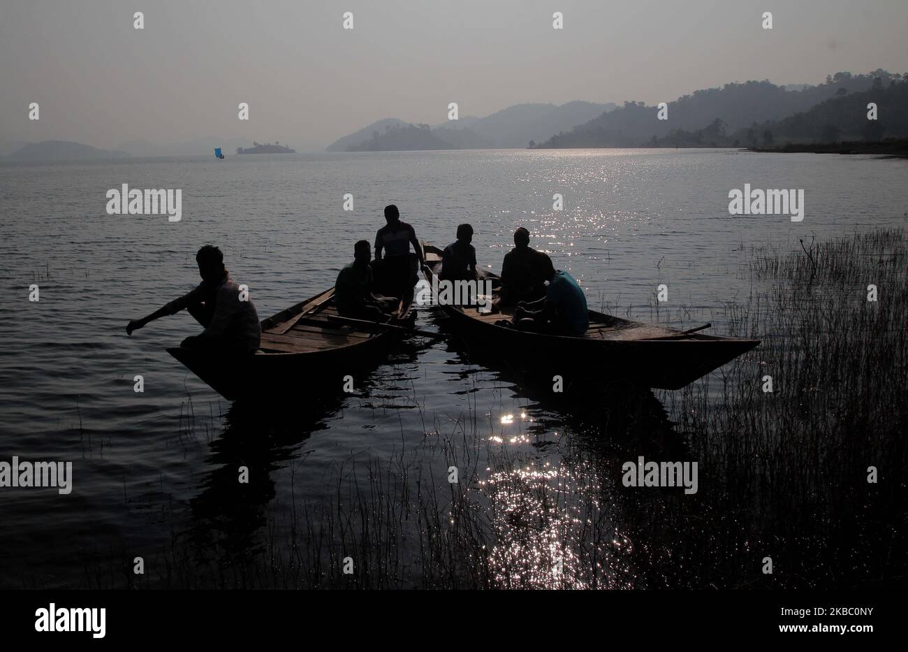 Villagers are seen inside the Balimela reservor as they moves out by ...