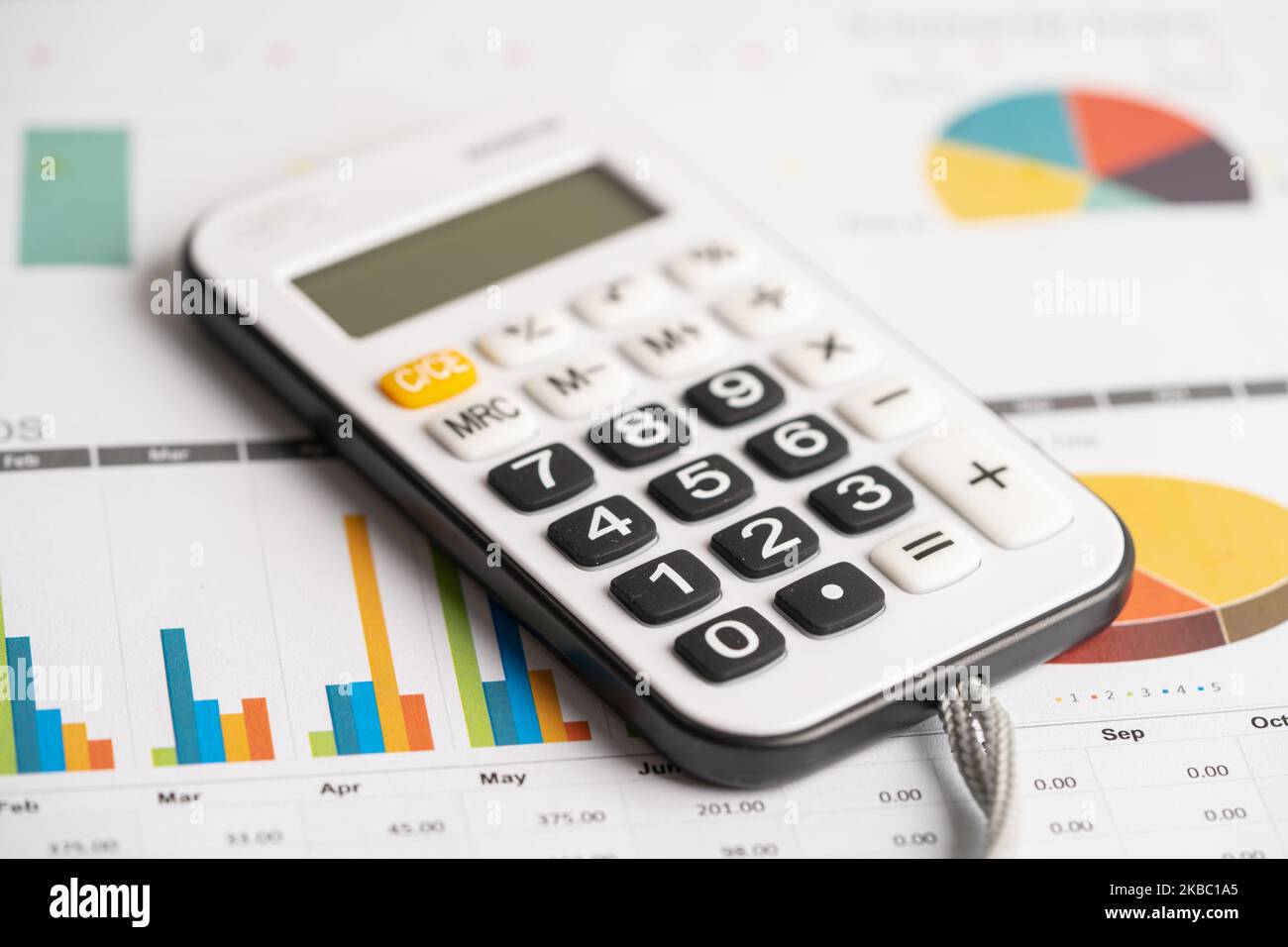 Calculator on preadsheet table paper with graph. Finance development ...