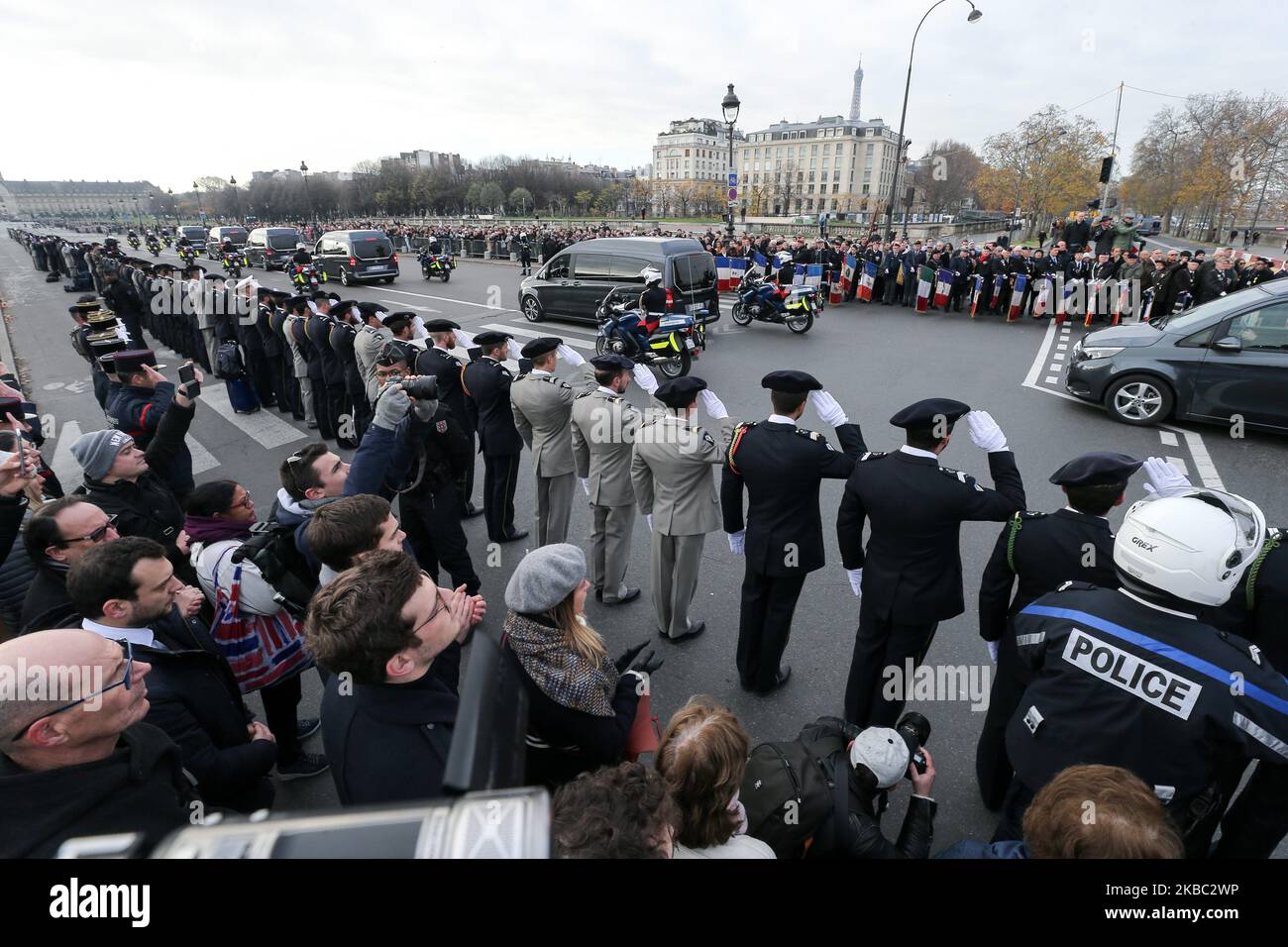 Soldiers and flag bearers salute as the funeral convoy passes on ...
