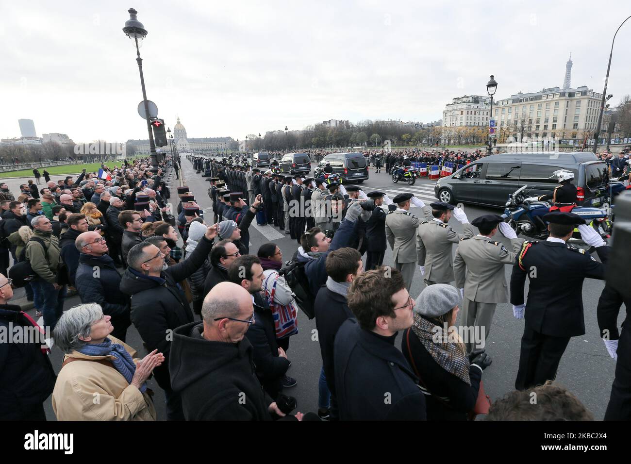 Soldiers and flag bearers salute as the funeral convoy passes on ...
