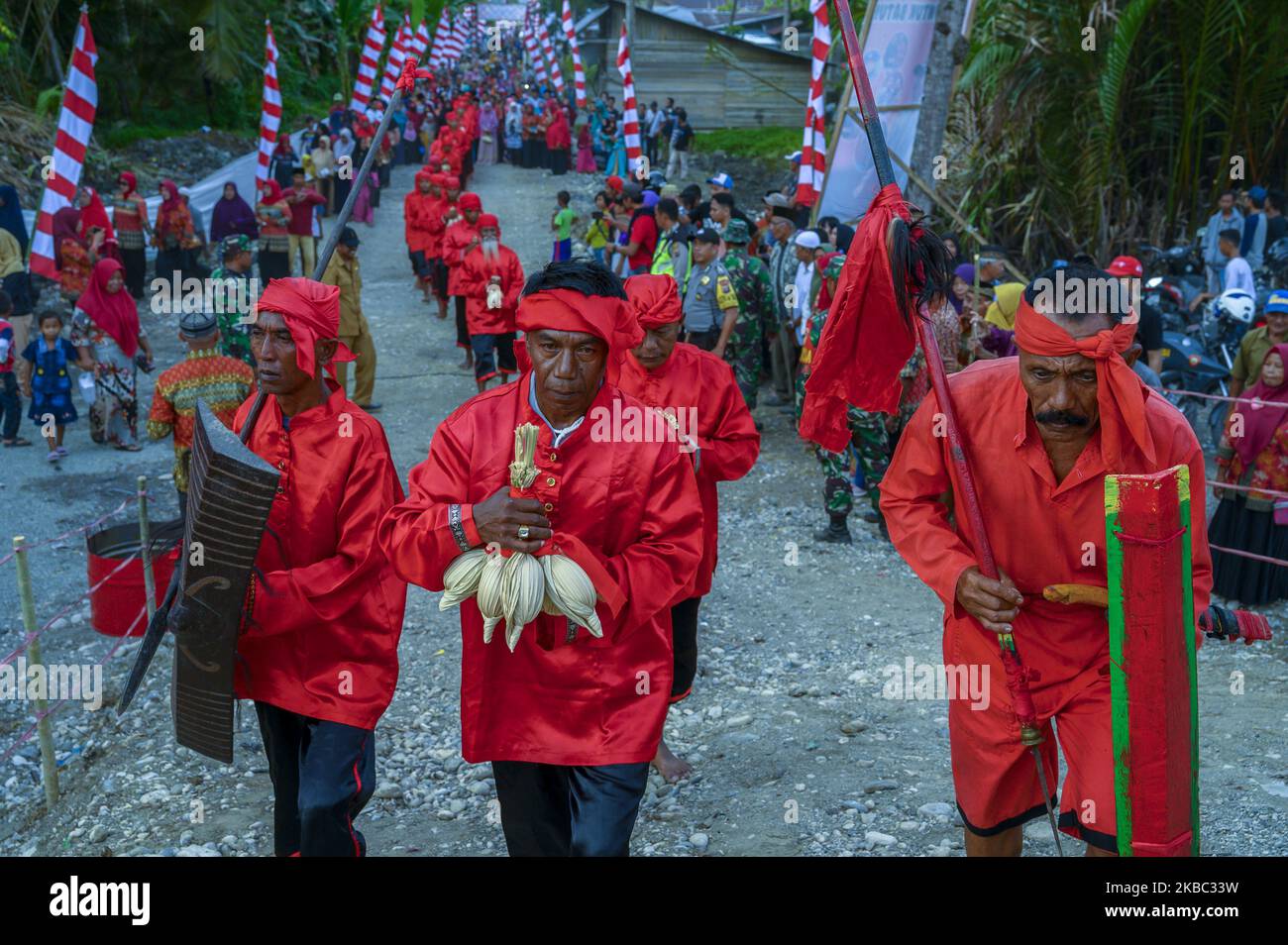The Batui indigenous people are accompanied by local residents carrying ...