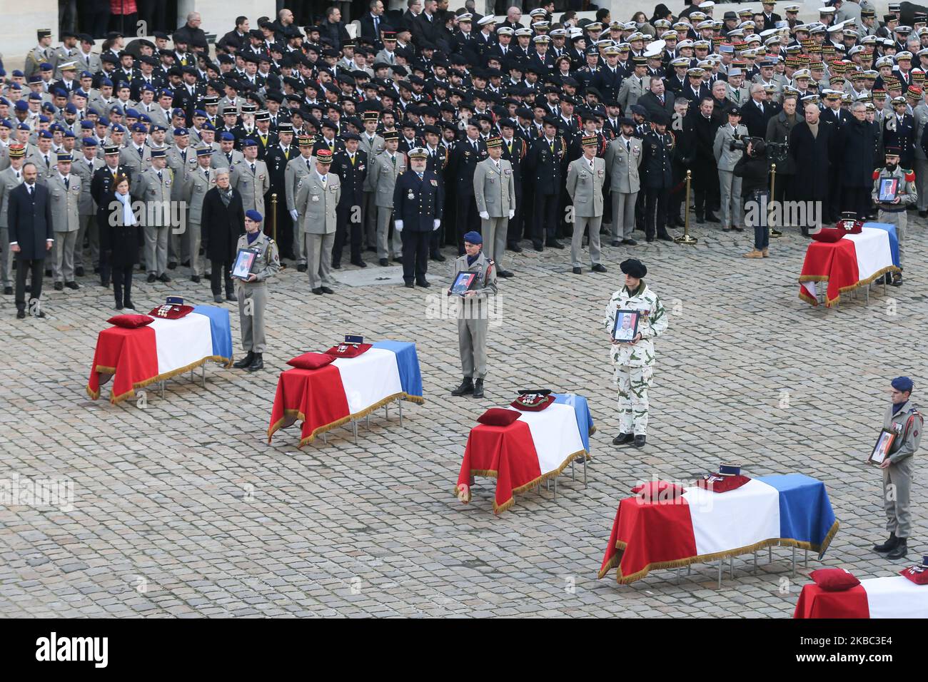 Soldiers, officials and relatives attend a tribute ceremony on December ...