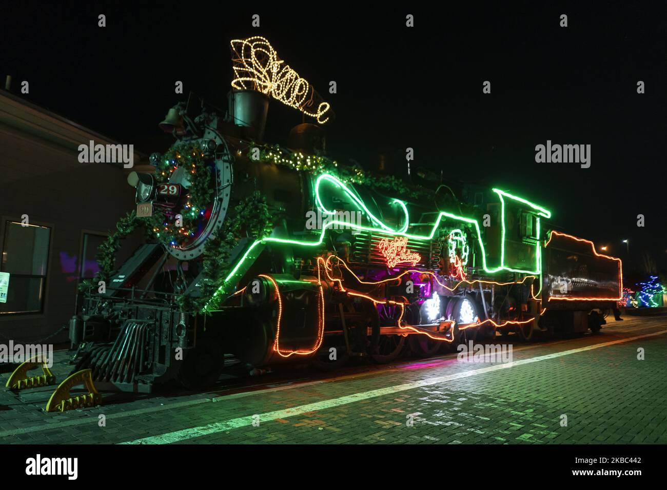 An old Polar Express train machine adorned with Christmas lights at ...