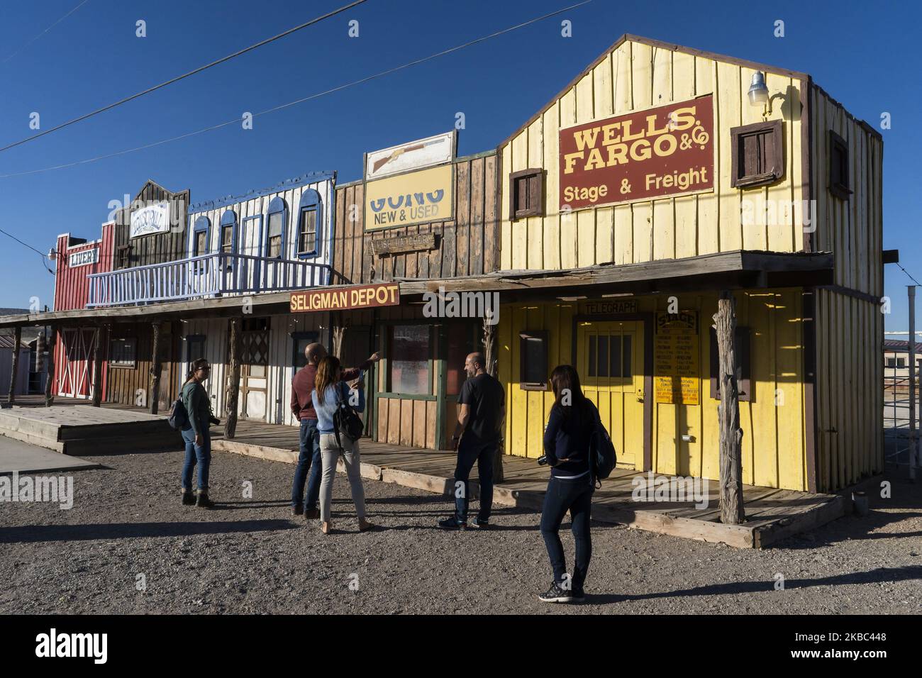 A group of tourists visit the reconstruction of a western town in the ...