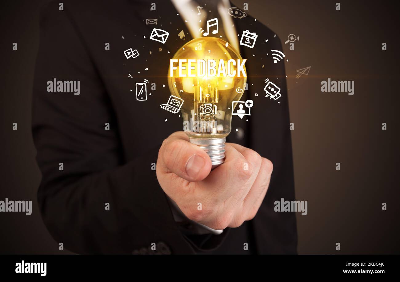 Businessman holding a light bulb, social media concept Stock Photo - Alamy