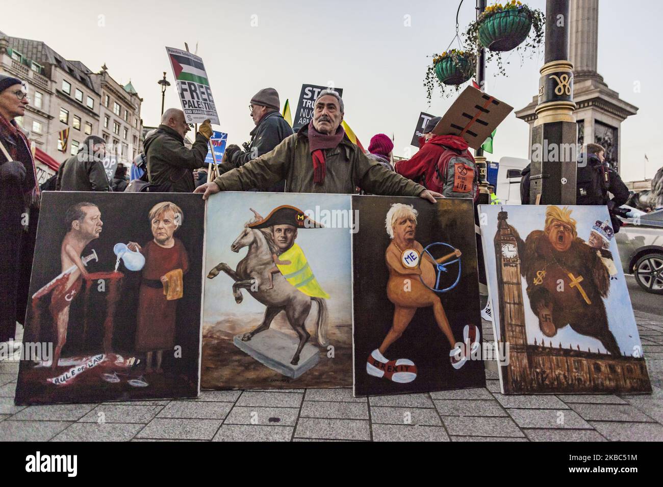 Protester shows parody paintings of some of the leaders members of the ...
