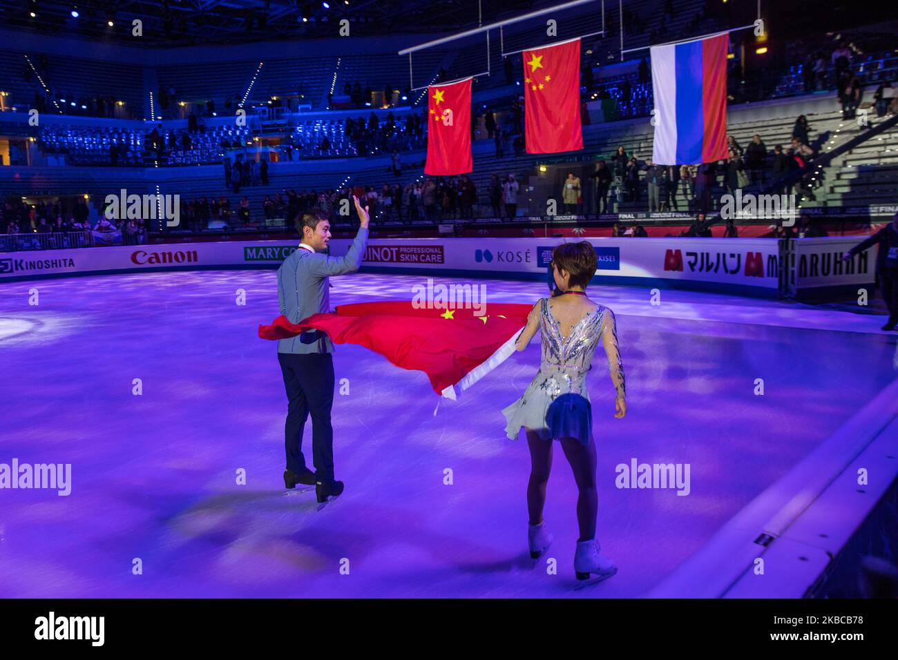Cheng Peng and Yang Jin of China with the national flag in the Pairs ...