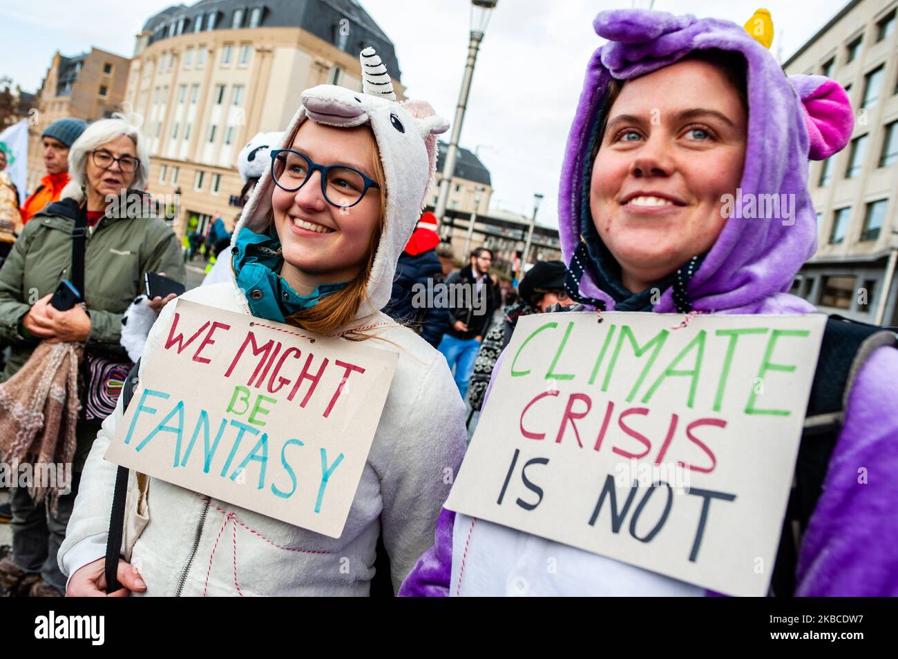 Two women are wearing unicorn costumes with placards, during the human ...